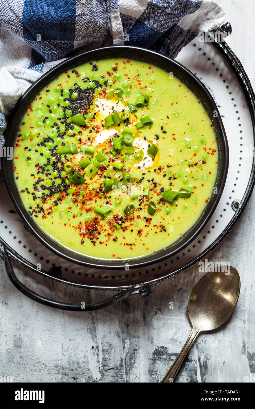 Bowl of Fresh green pea soup with spring onions Stock Photo - Alamy
