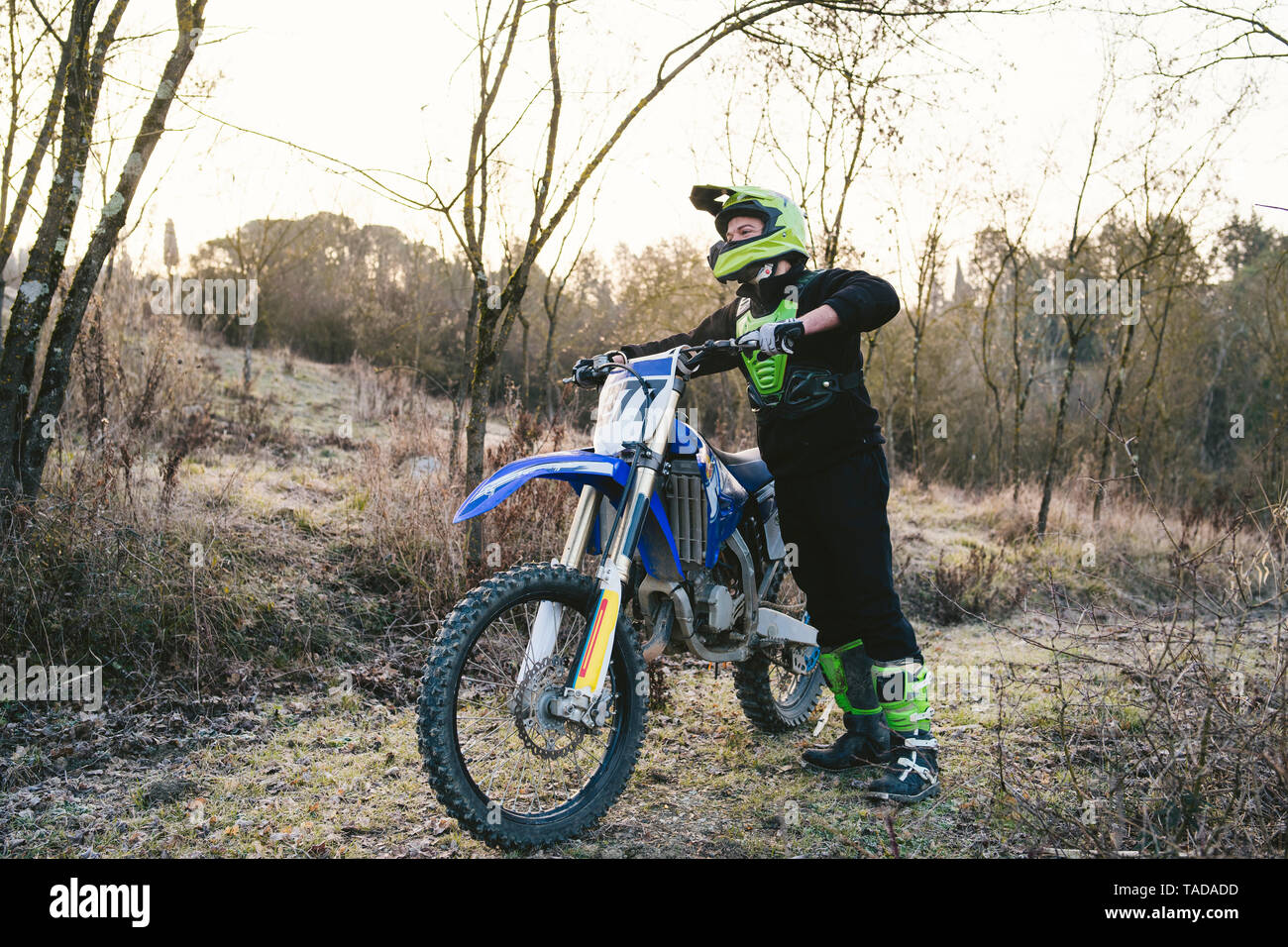 Motocross driver standing on circuit Stock Photo - Alamy