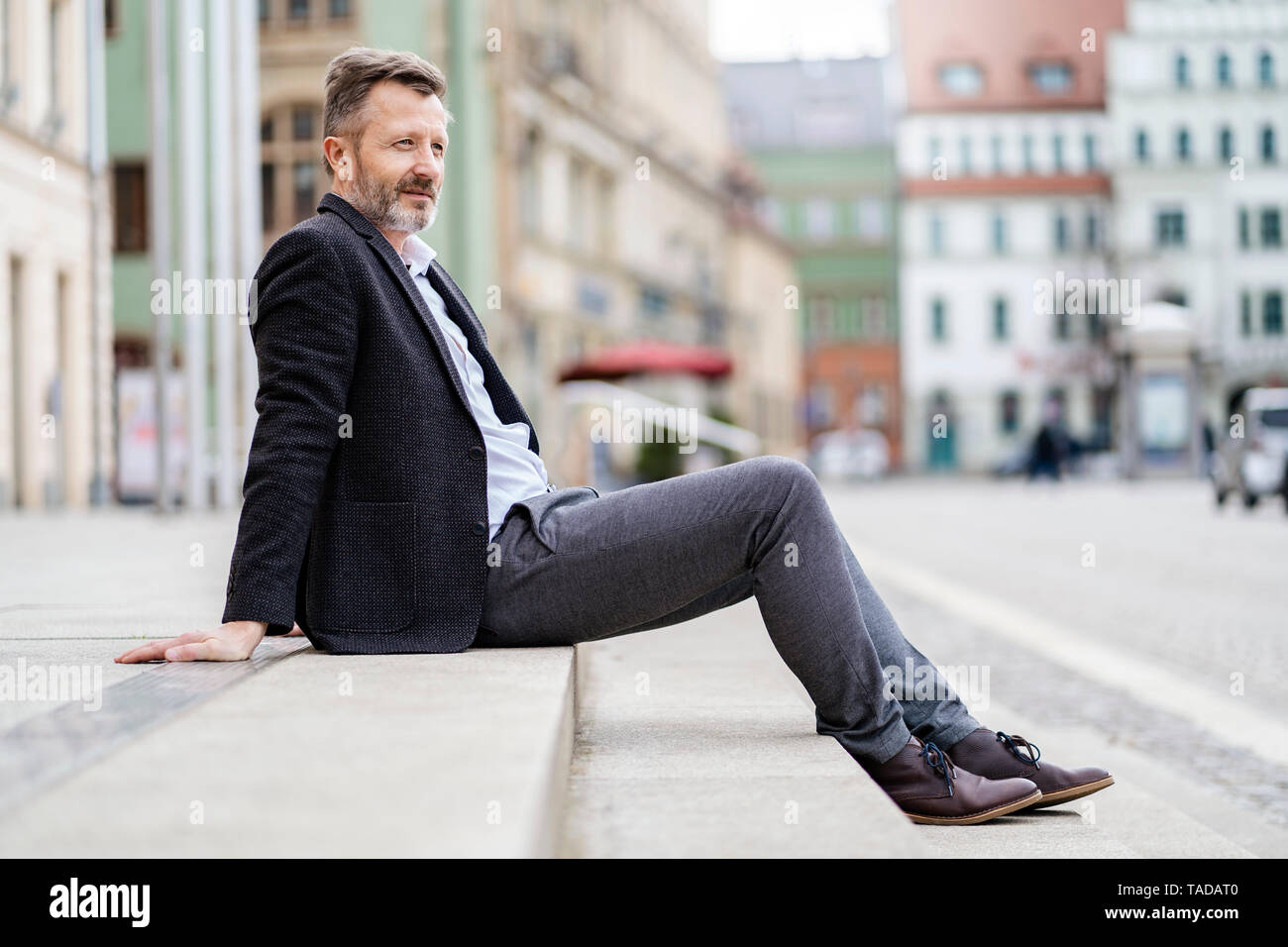 Person sitting on steps hi-res stock photography and images - Alamy
