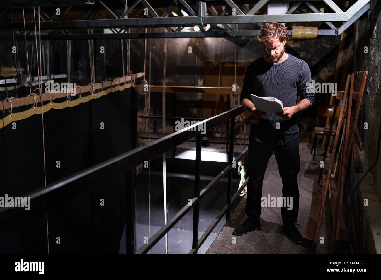 Actor at theatre studying script backstage Stock Photo - Alamy