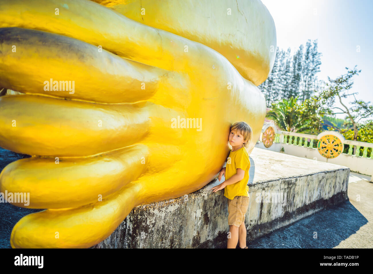 Happy boy tourist on background ofLying Buddha statue Stock Photo - Alamy