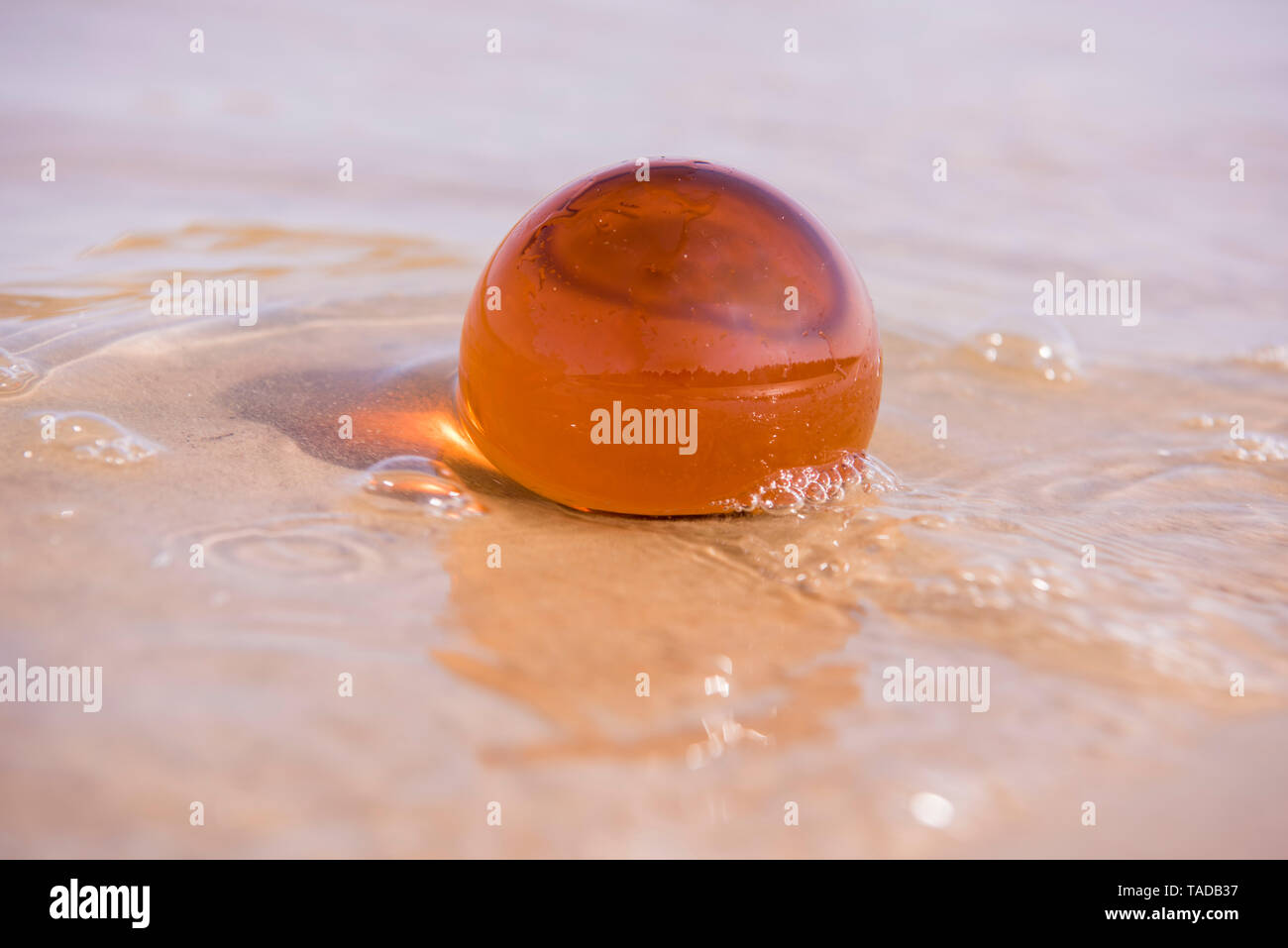 Glass sphere at the beach. Sunny summer day Stock Photo - Alamy