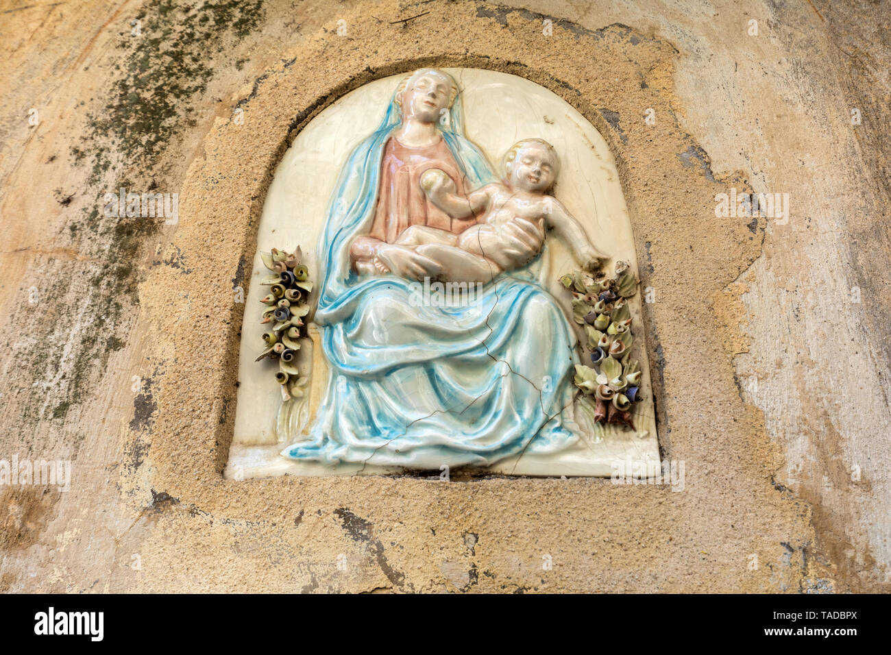 Ceramic bas-relief of the Virgin Mary with Jesus on the wall of the ...