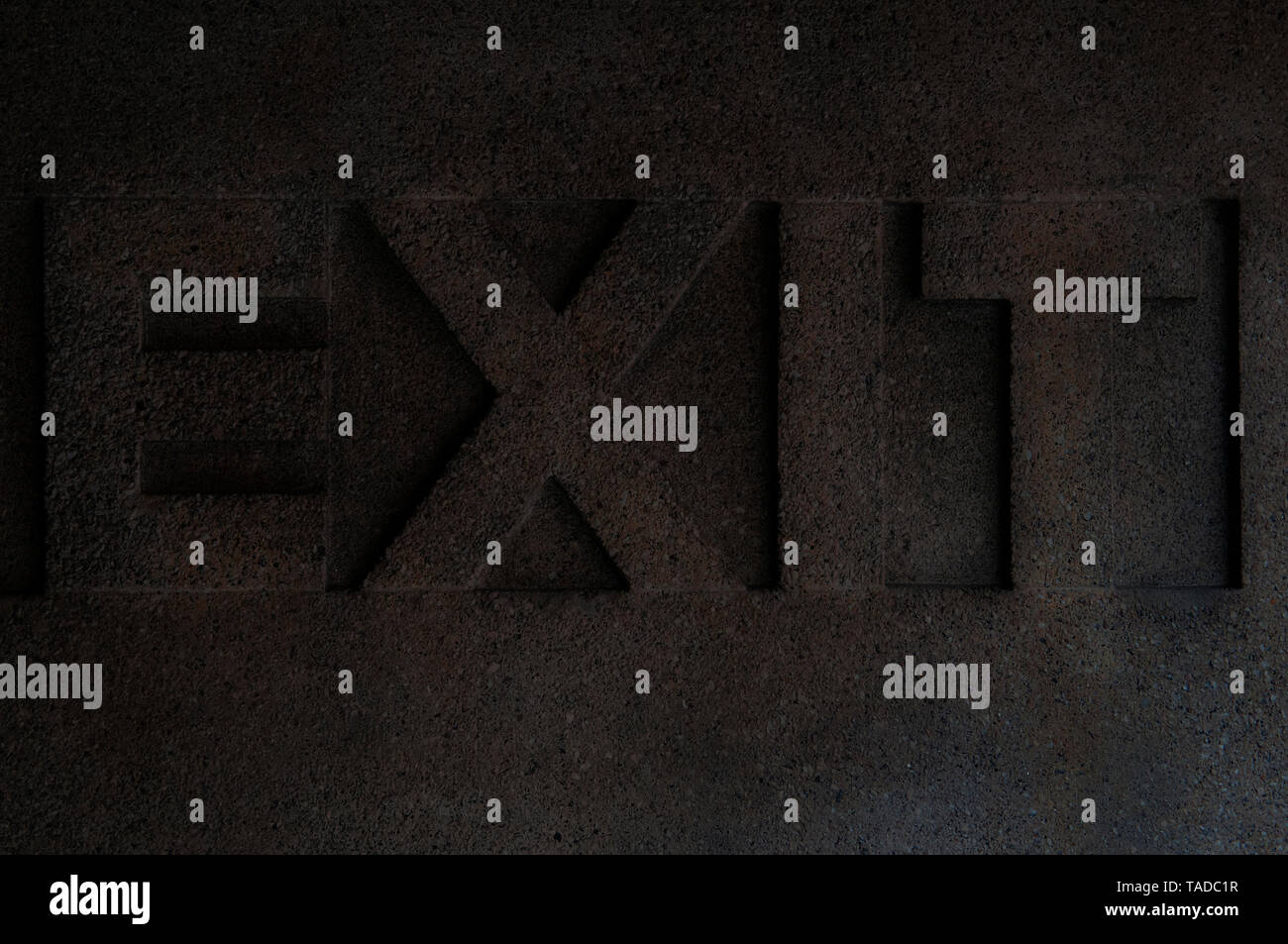 The Word Exit In Capital Letters Carved Into Stone Stock Photo - Alamy
