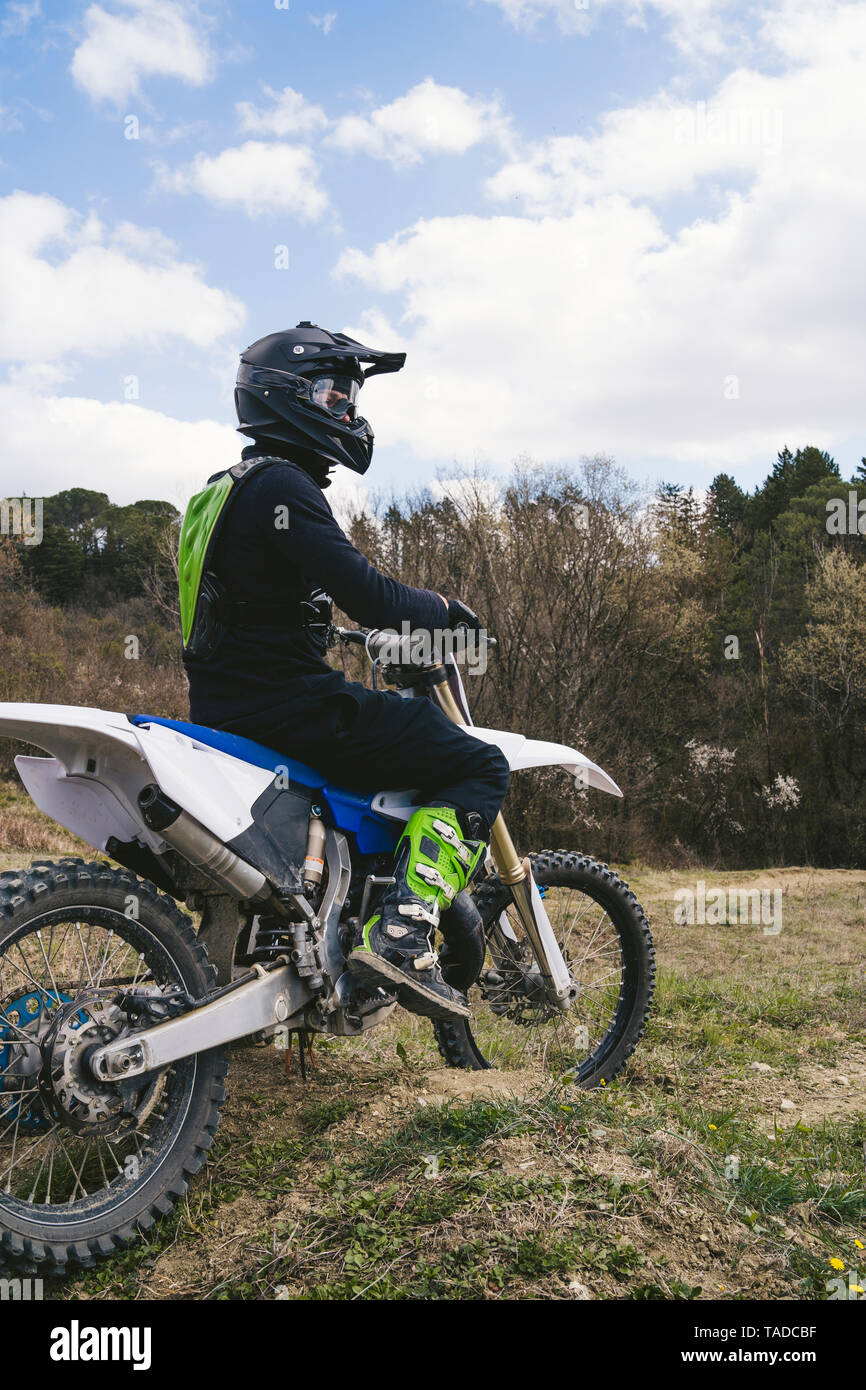 Motocross driver standing on circuit Stock Photo - Alamy
