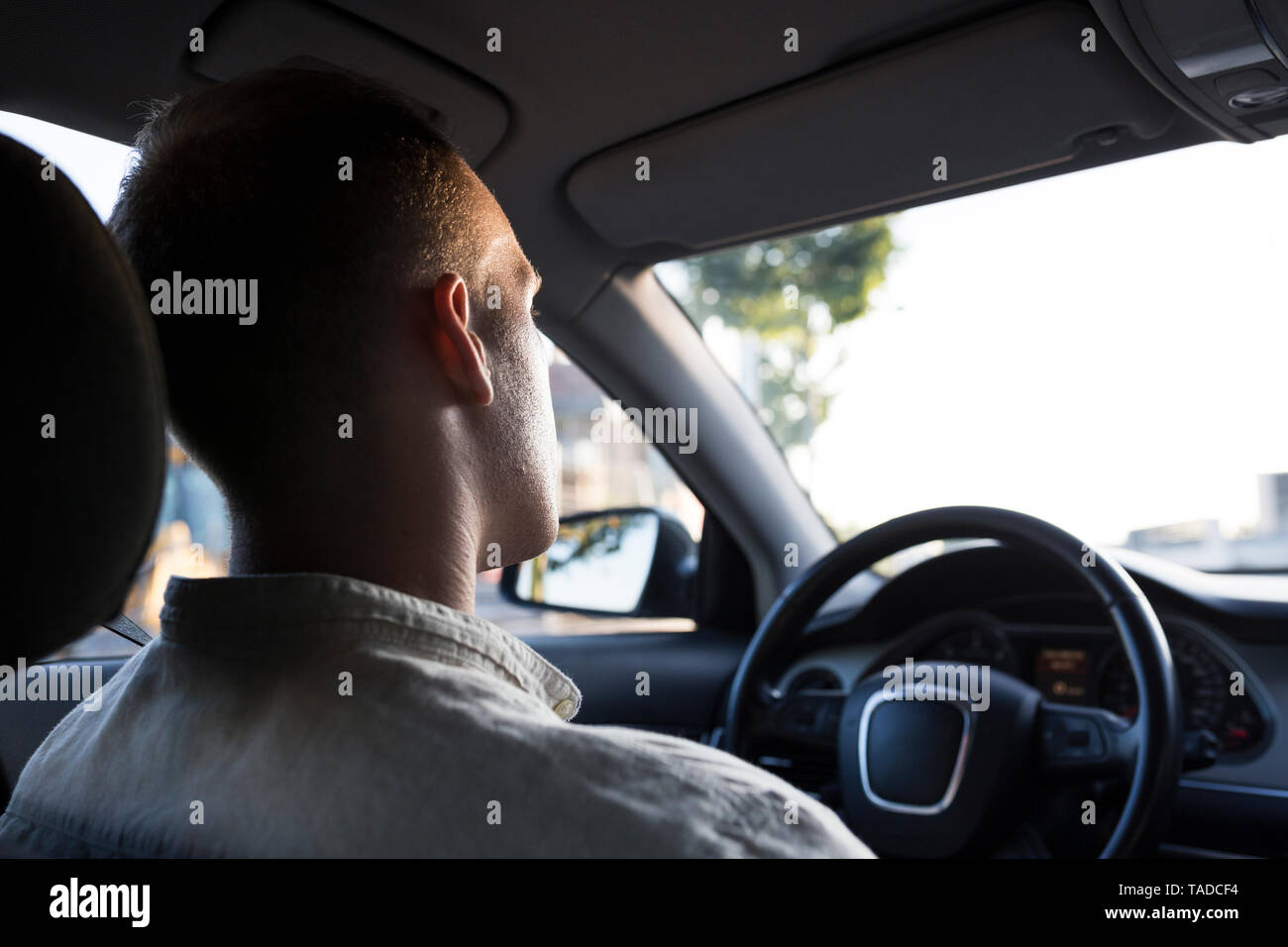 Rear view man driving car hi-res stock photography and images - Alamy