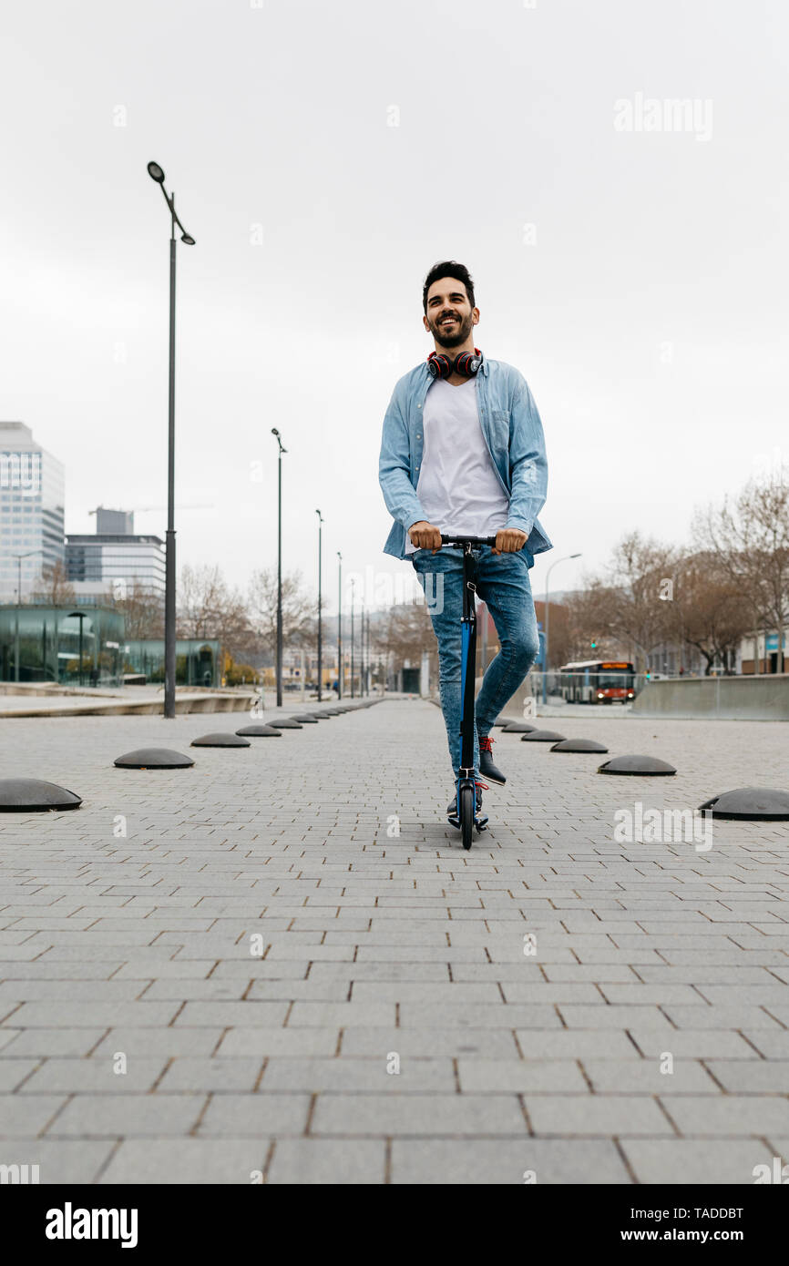 Man commuting in the city, using his kickboard Stock Photo - Alamy