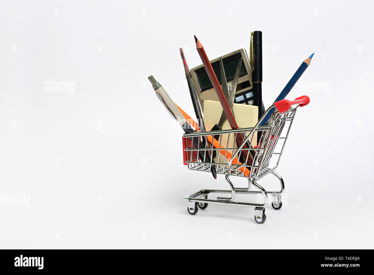 Shopping cart full with education goods for study om white background ...