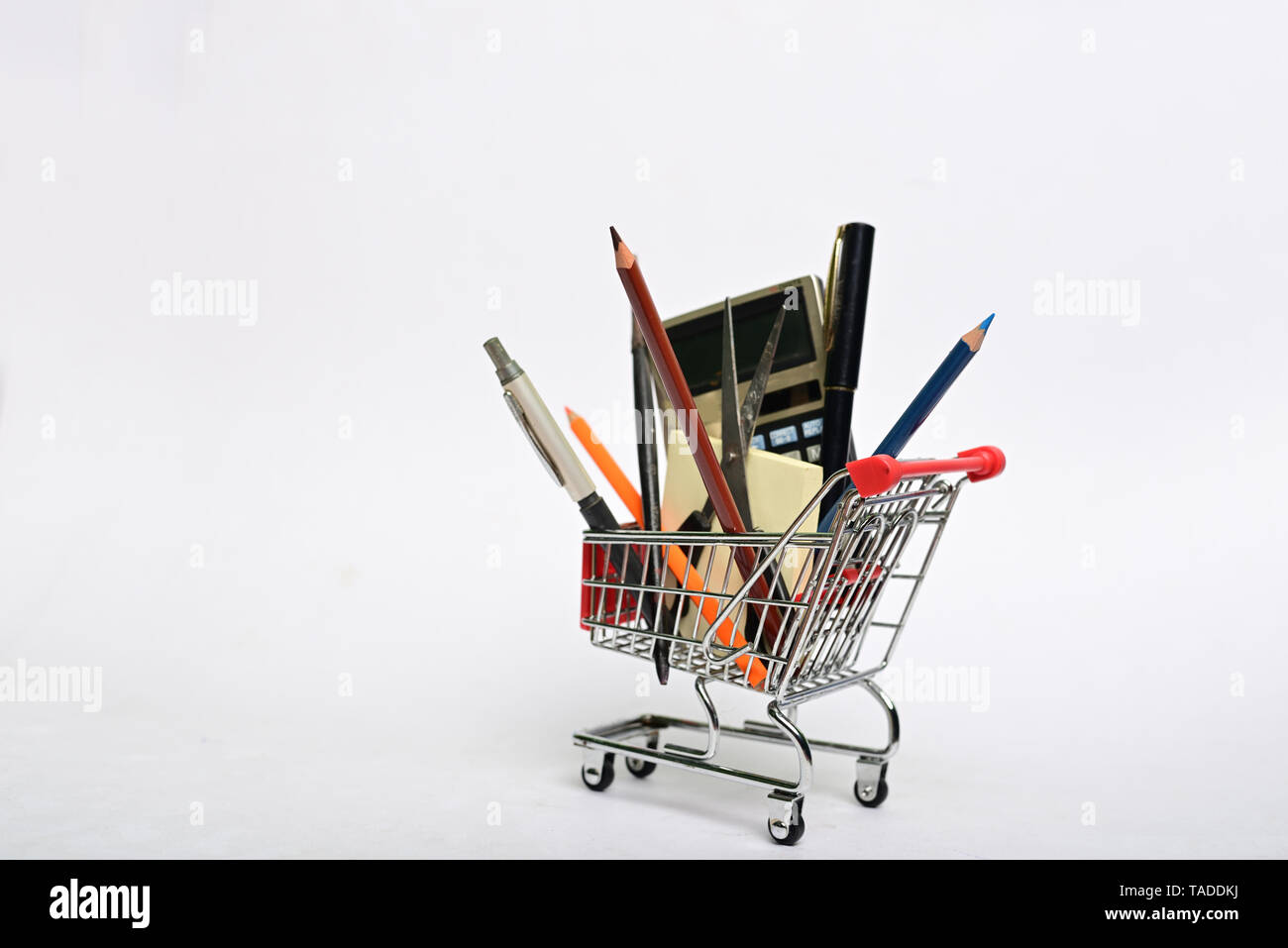Shopping cart full with education goods for study om white background ...