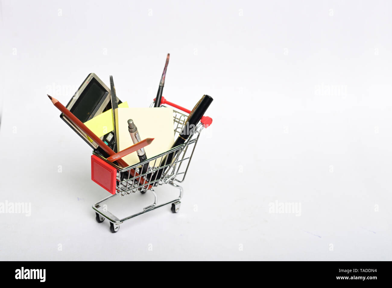 Shopping cart full with education goods for study om white background ...