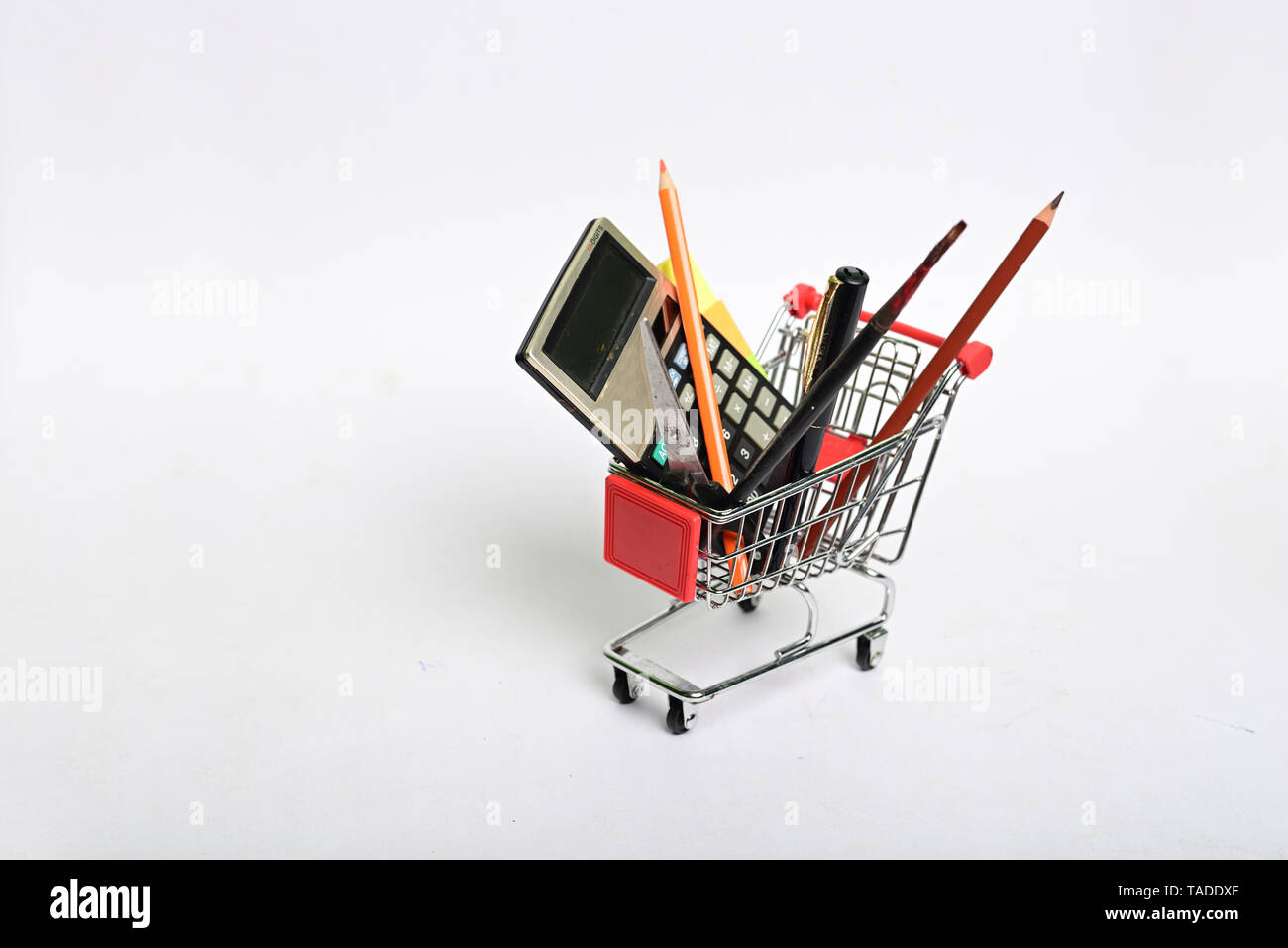Shopping cart full with education goods for study om white background ...