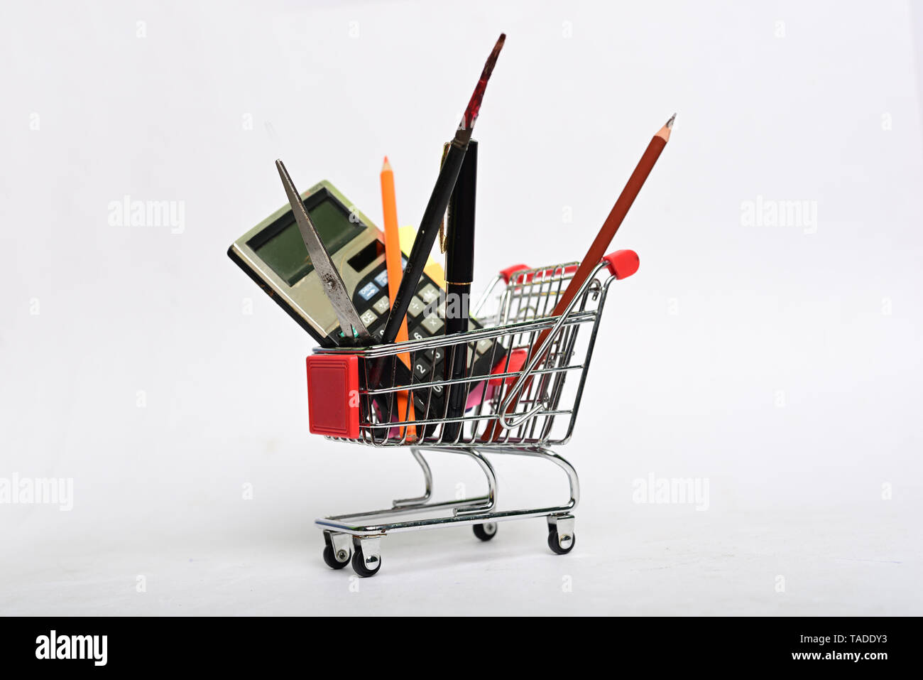 Shopping cart full with education goods for study om white background ...