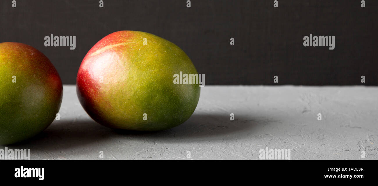 Two colorful sweet mangoes, side view. Copy space Stock Photo - Alamy
