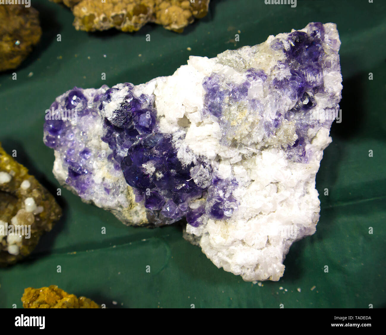 Large piece of raw fluorite with calcite between other stone fragments ...