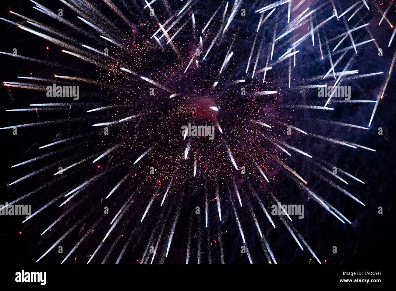 Fireworks against the dark sky. red black Stock Photo - Alamy