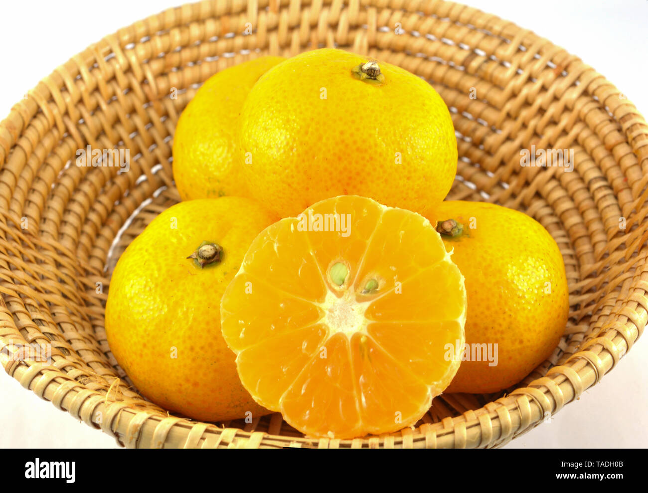 small chinese orange mandarin in basket isolated on white background ...