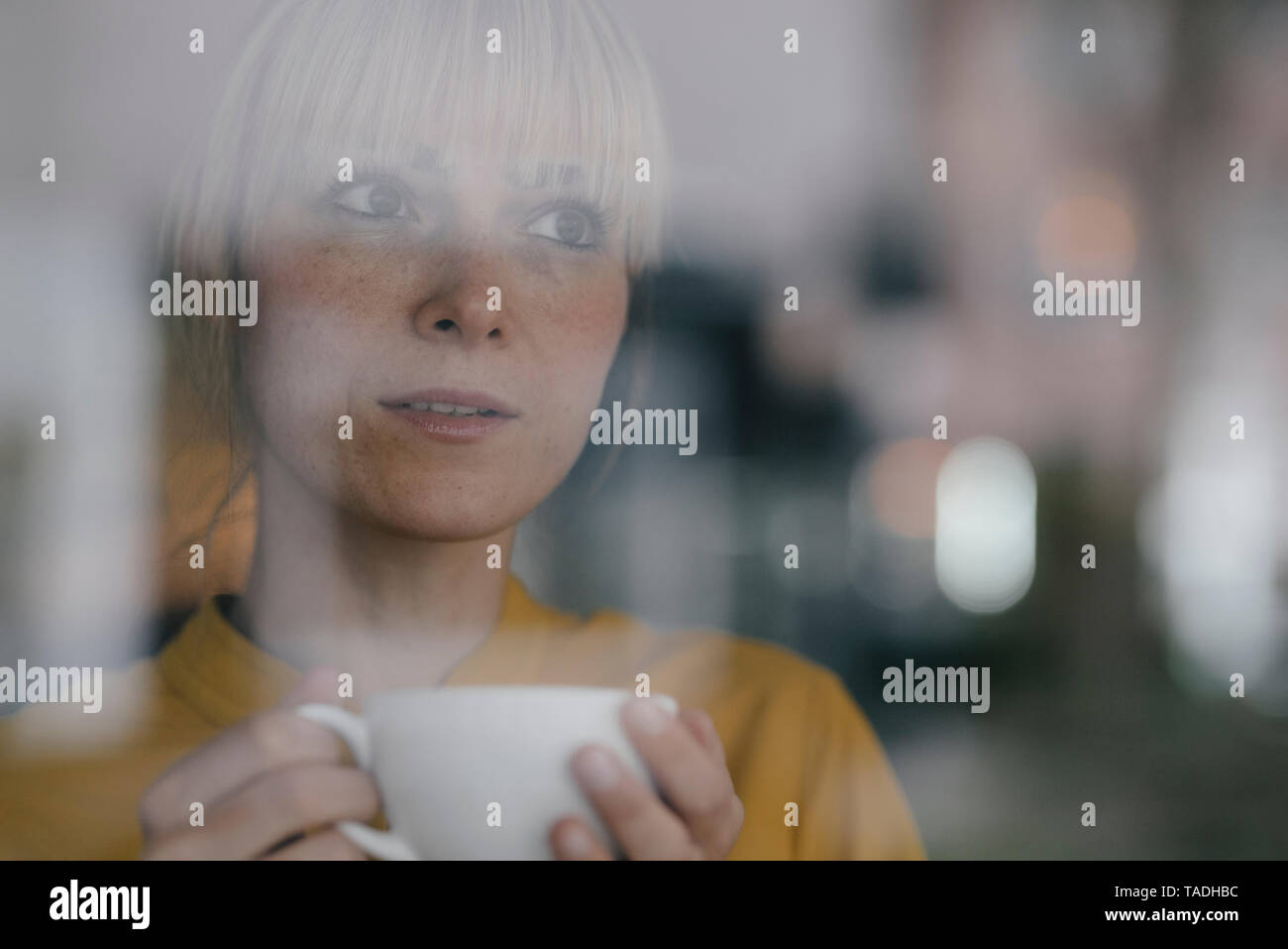 Portrait blond woman drinking coffee window hi-res stock photography ...