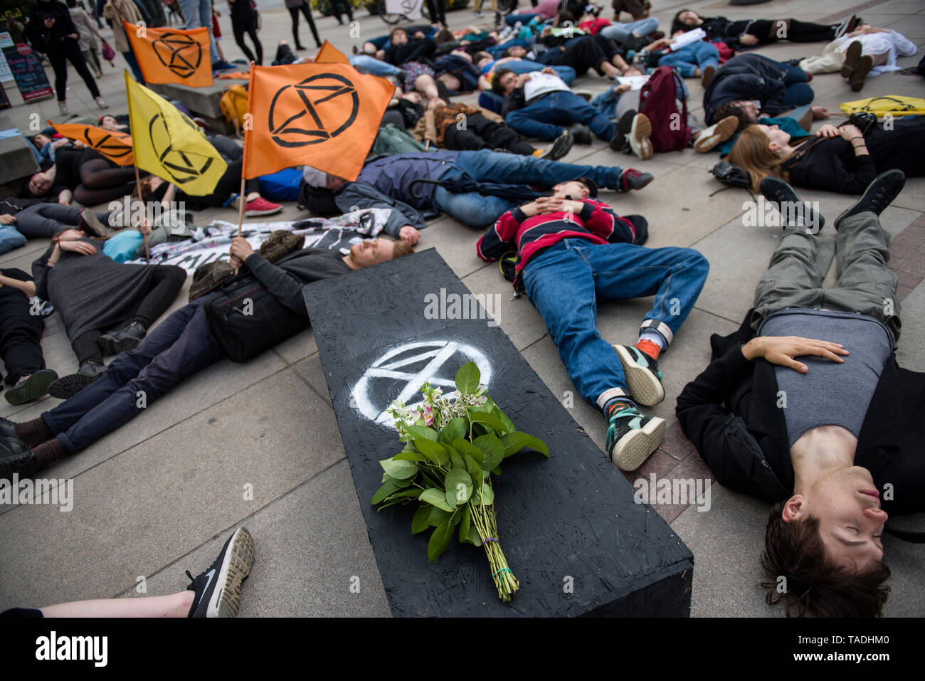 A coffin with flowers, seen among activist laying on the side walk ...