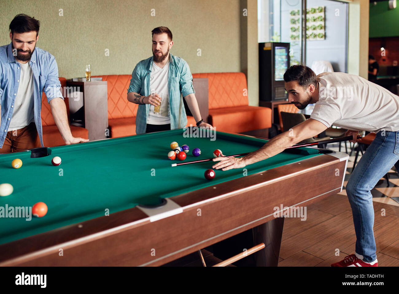 Friends playing billiards together Stock Photo - Alamy