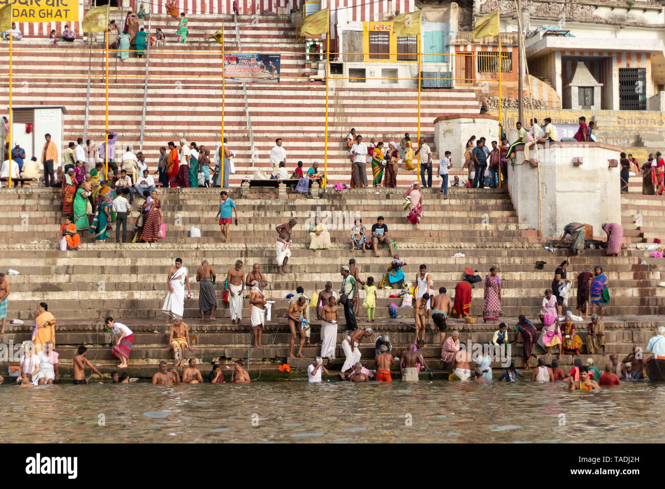 People at the Ghats early in the morning saying their prayers and ...