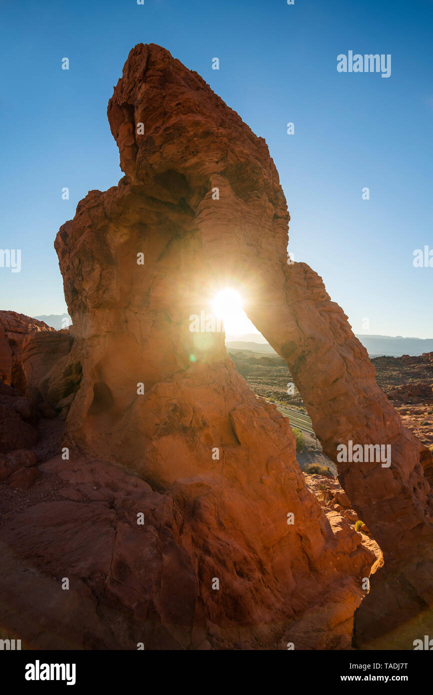 USA, Nevada, Redrock sandstone arch at sunrise in the Valley of Fire ...