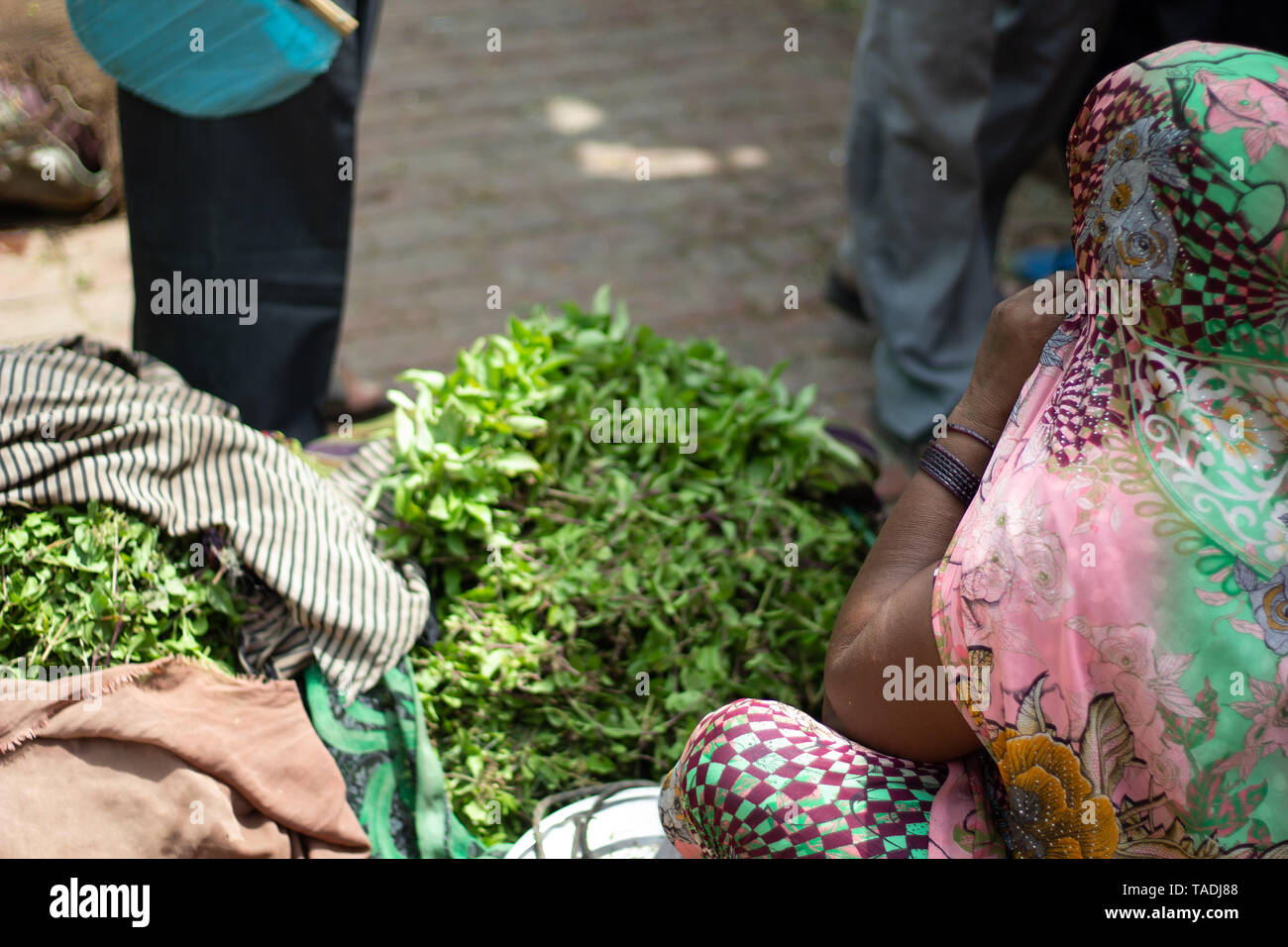 Indian woman selling basil leafs at the Varanasi flower market Stock ...