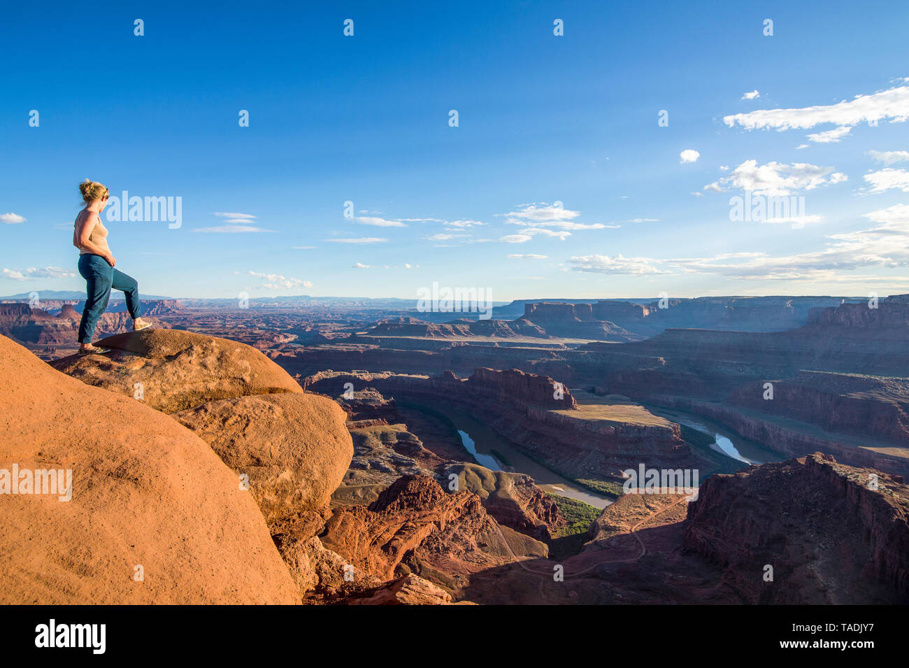 USA, Utah, Woman at a overlook over the canyonlands and the Colorado ...