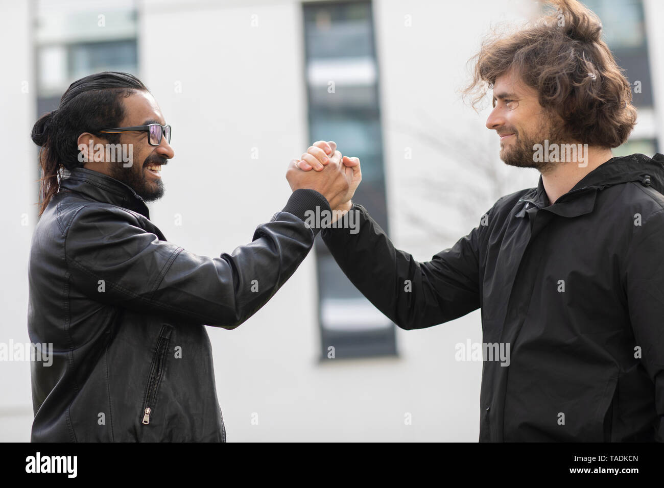 Two friends greeting each other Stock Photo - Alamy