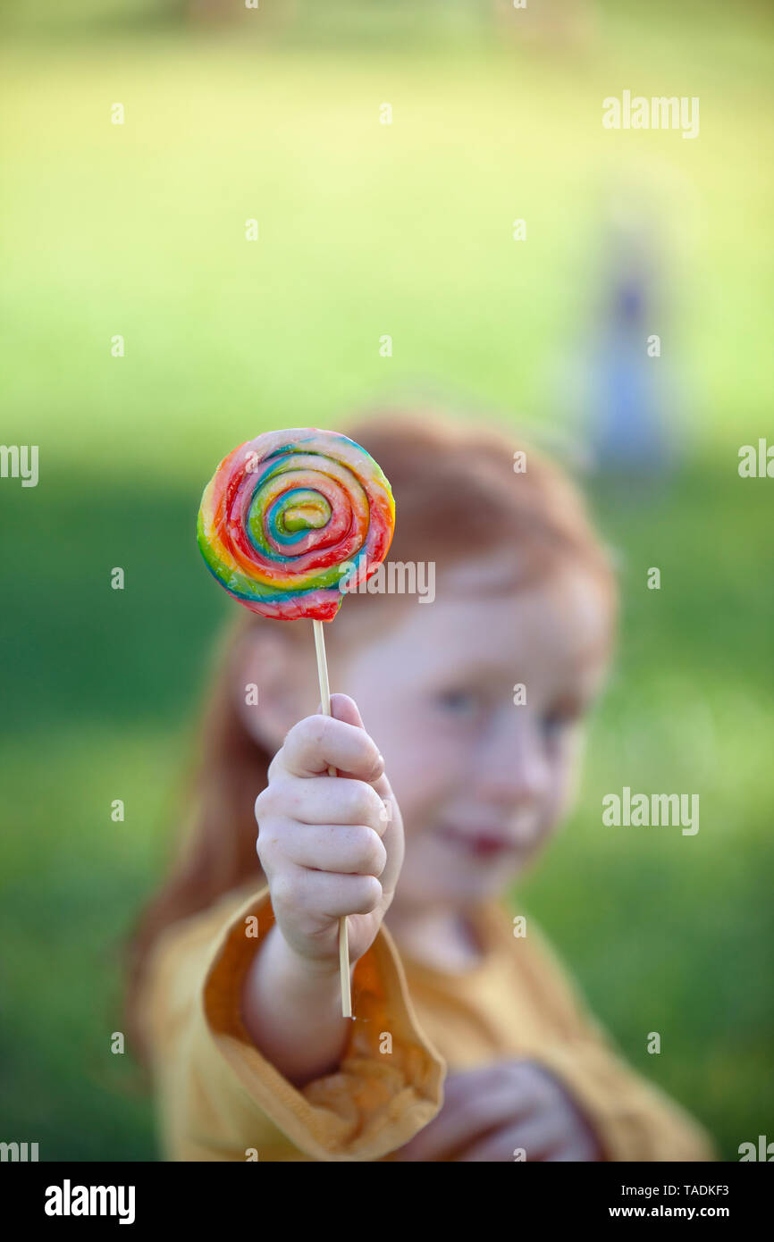 Hand holding lollipop hi-res stock photography and images - Alamy