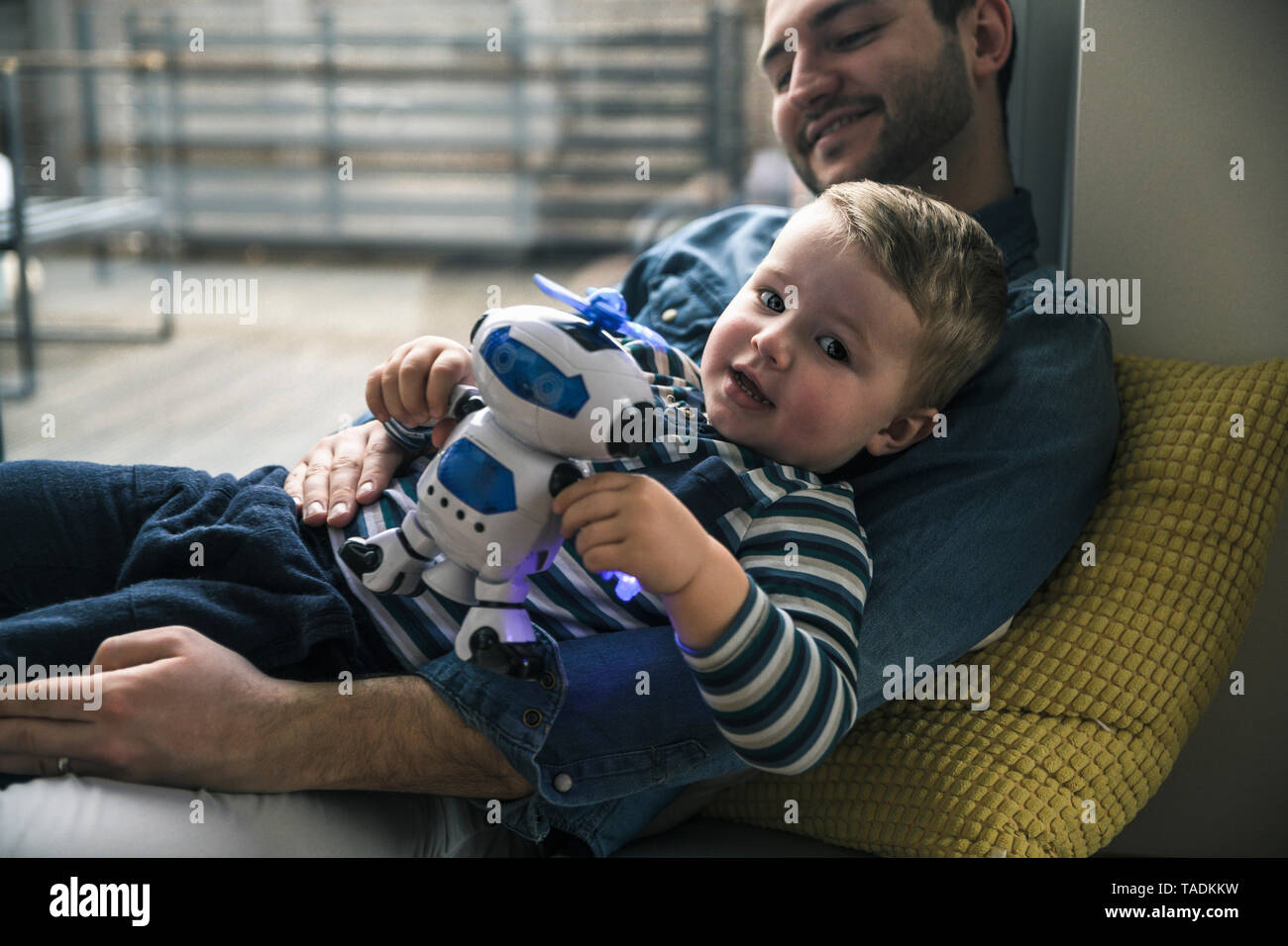 Father and son playing with a toy robot at home Stock Photo - Alamy