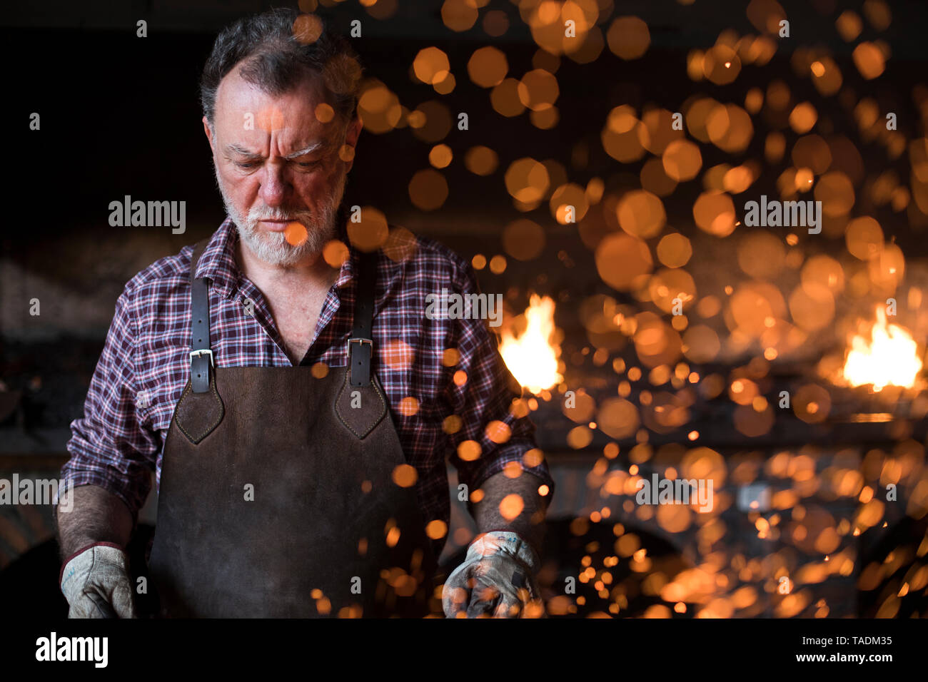Blacksmith at work in his workshop Stock Photo - Alamy