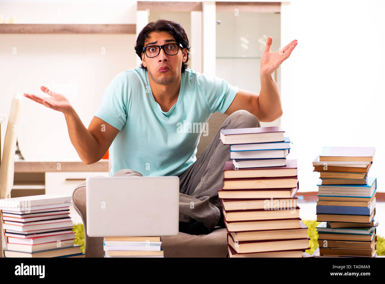 Teenager revising laptop books at home hi-res stock photography and ...