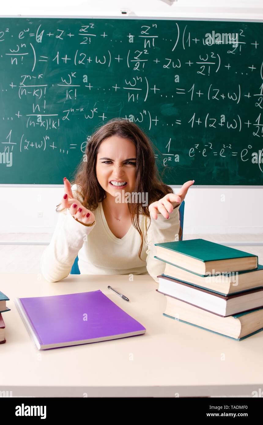 Young female math teacher in front of chalkboard Stock Photo - Alamy