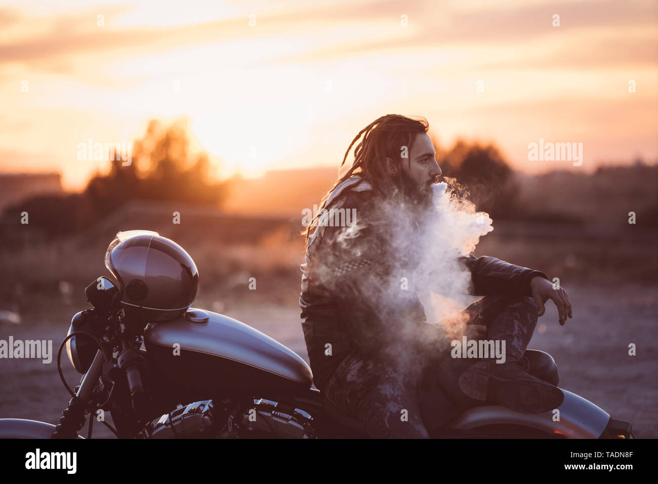 Man with dreadlocks sitting hi-res stock photography and images - Alamy