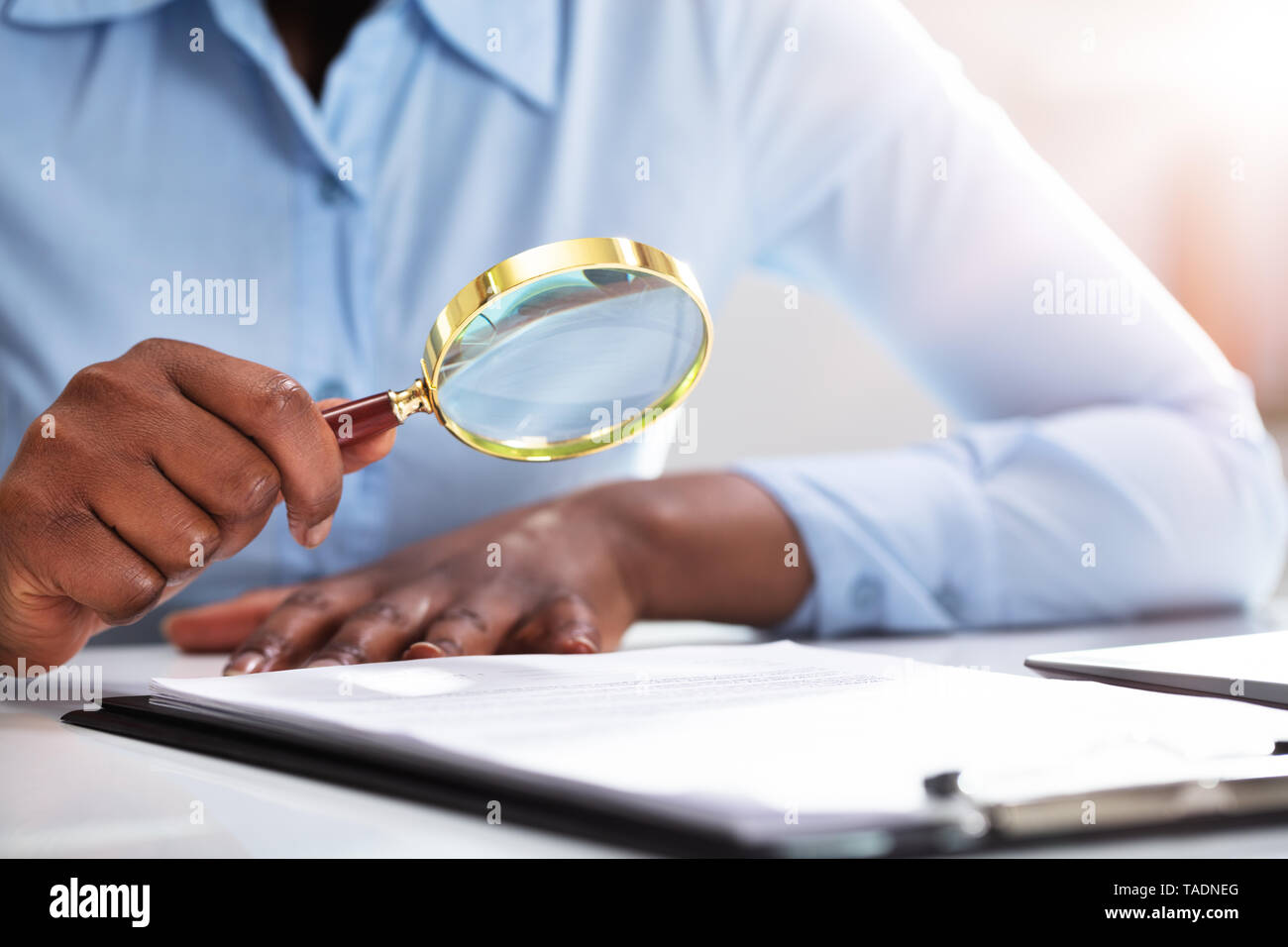 Close-up Of A Businessperson's Hand Looking At Contract Form Through ...