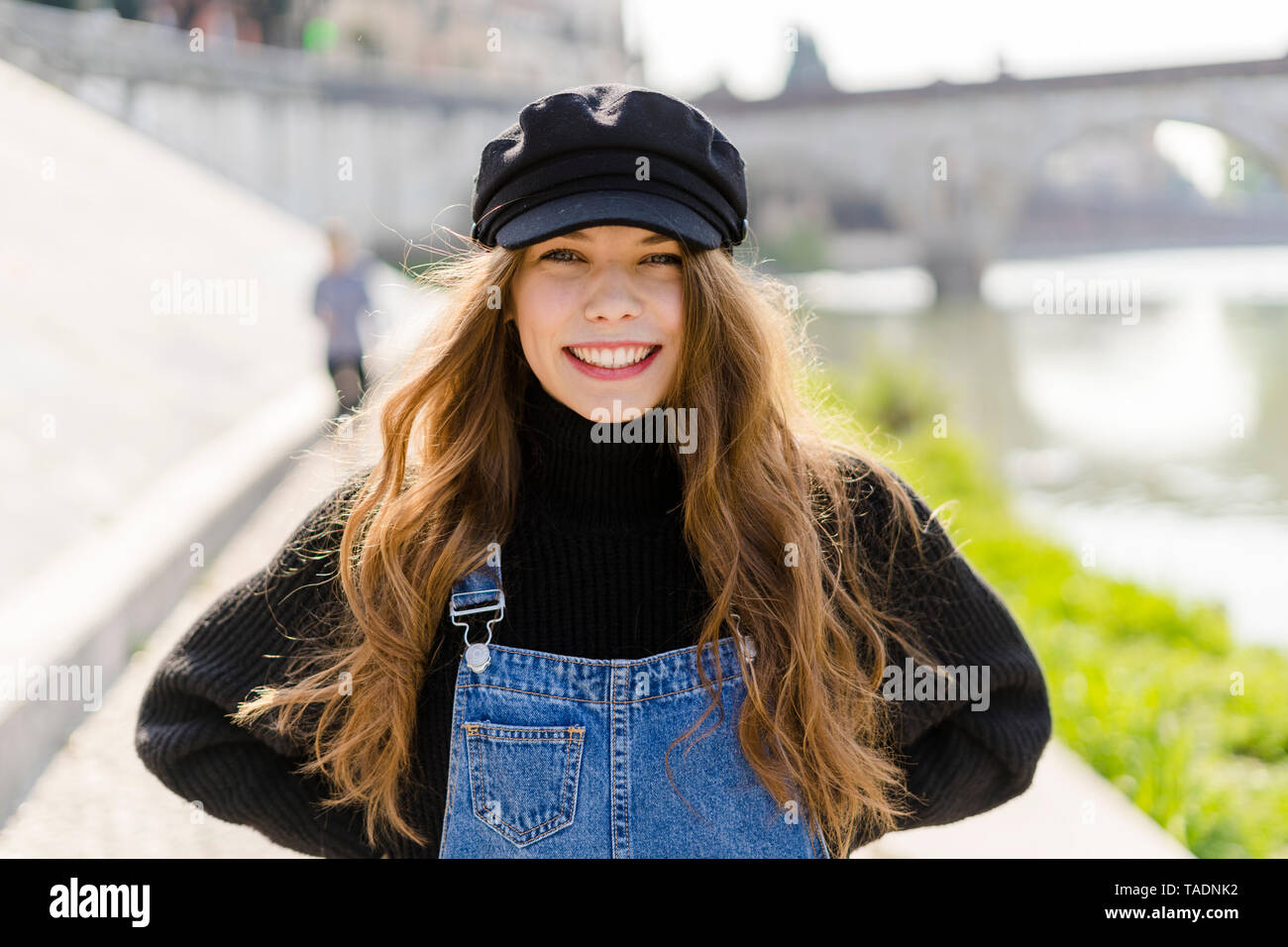 Portrait of smiling young woman at the riverside hi-res stock ...