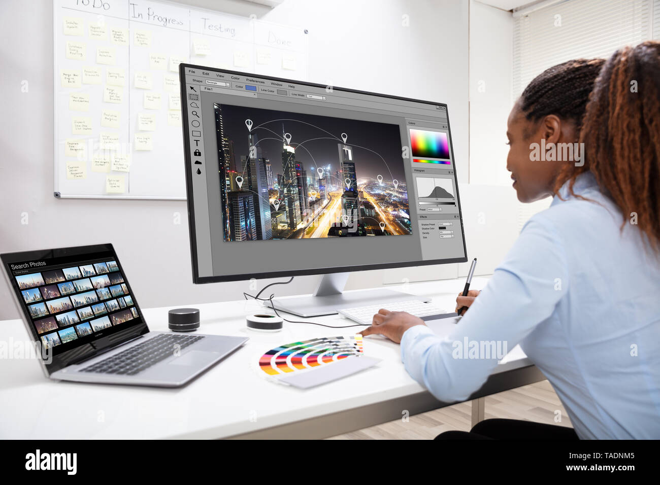Young Female Designer Editing Photos On Computer In Office Stock Photo ...