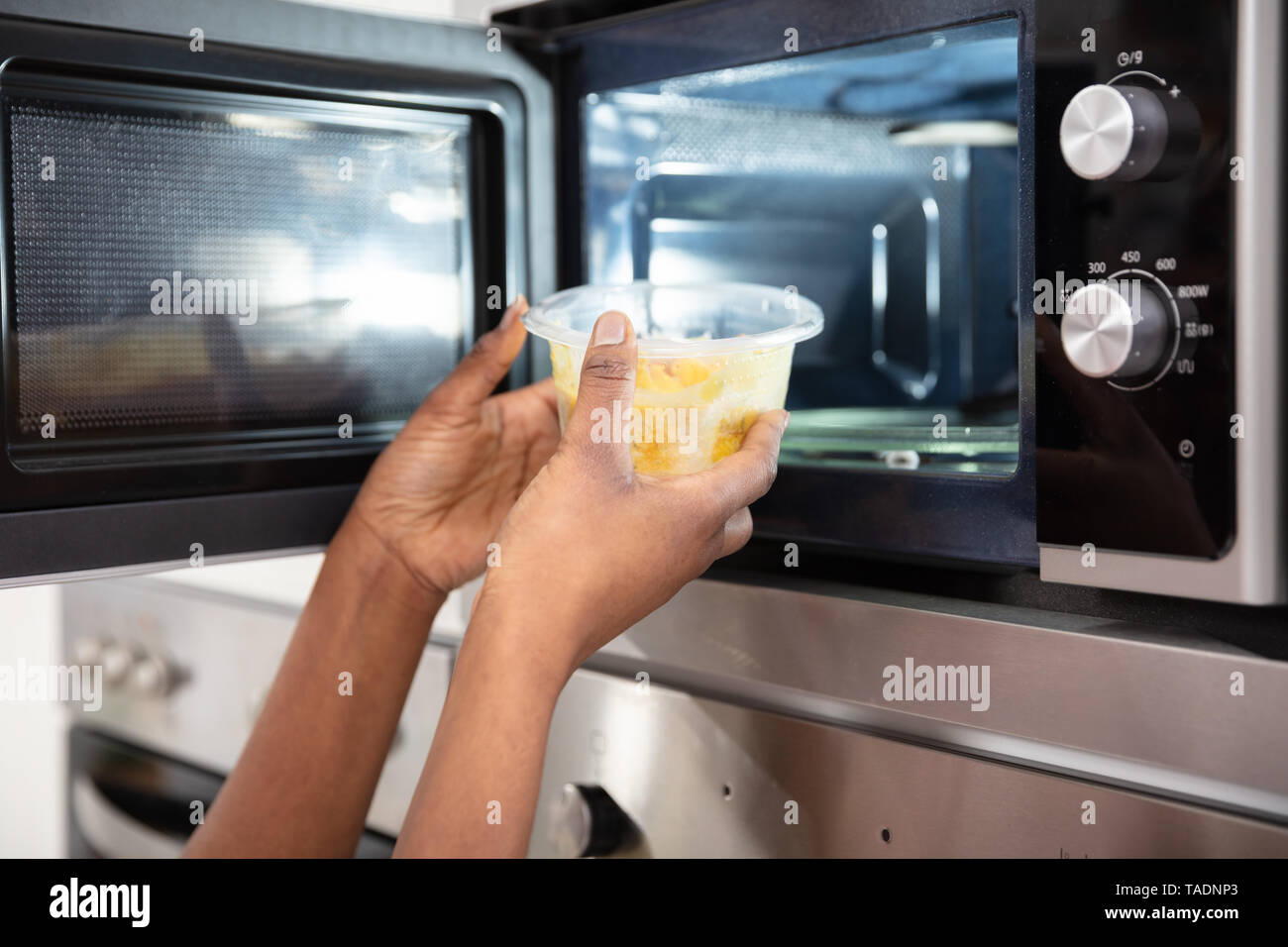 Close-up Of A Human's Hand Heating Food In Microwave Oven Stock Photo ...