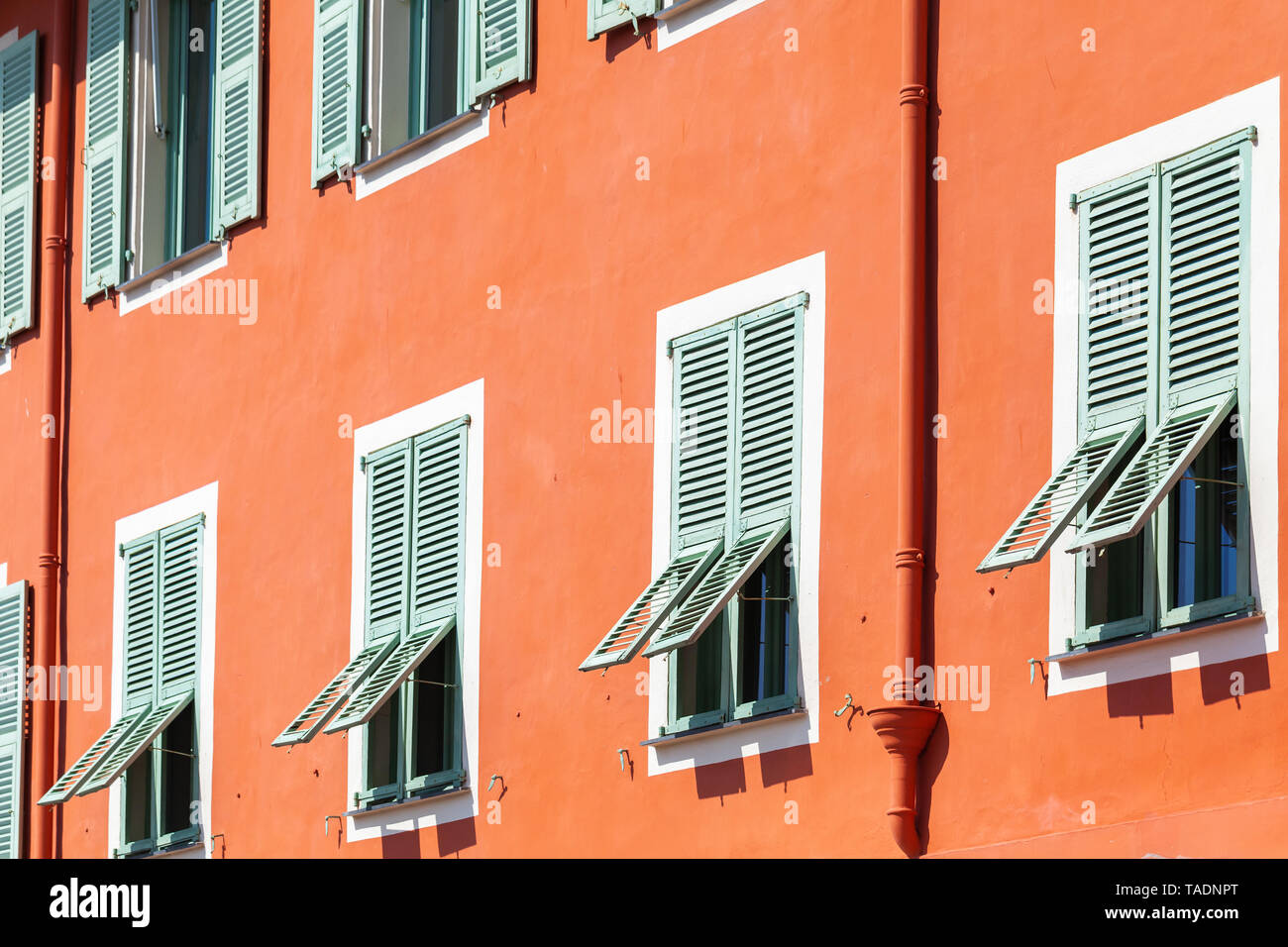 Facade of a house in the old town of Nice. Windows with shutters ...