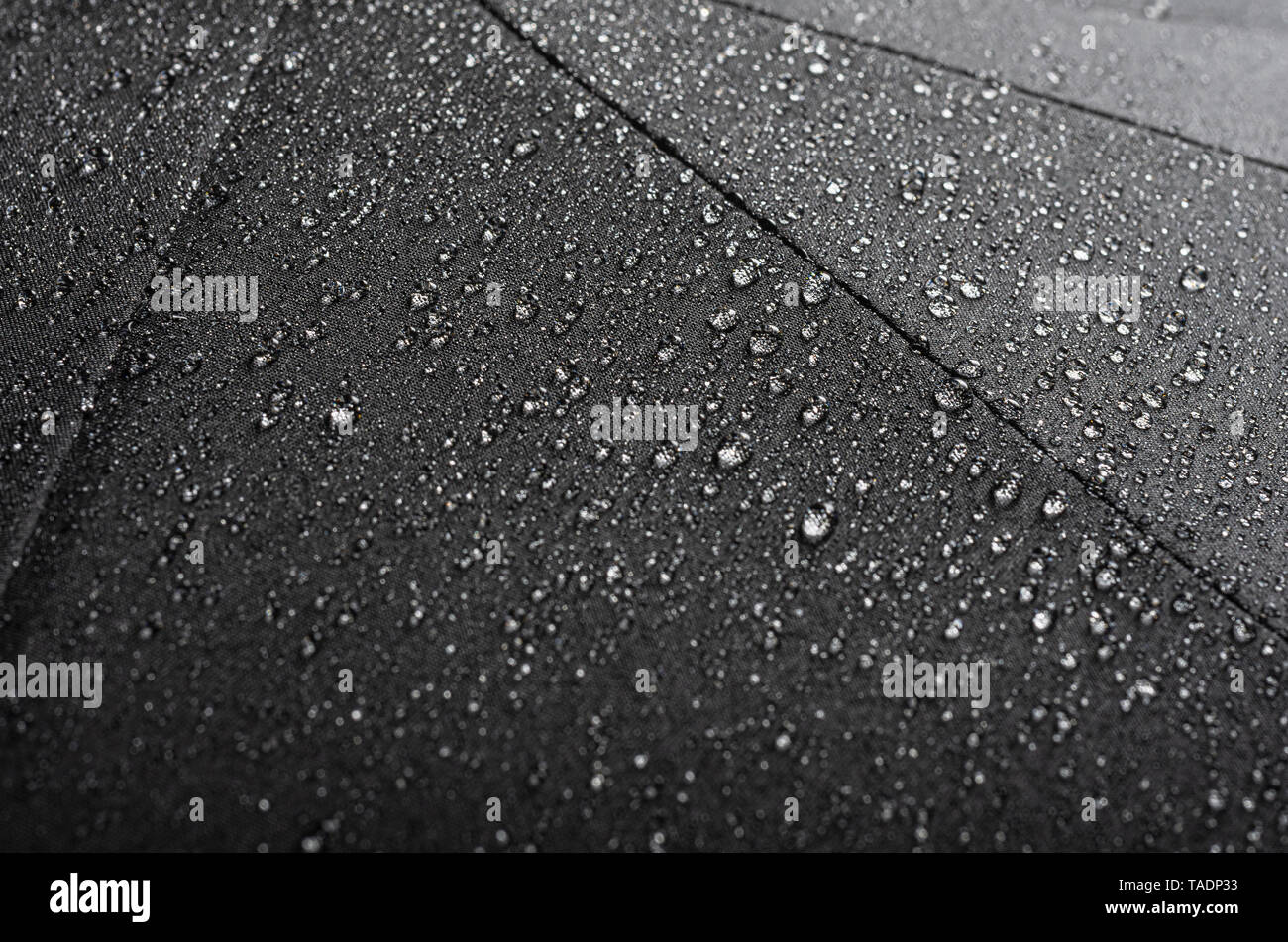 Black waterproof umbrella texture with water droplets Stock Photo - Alamy