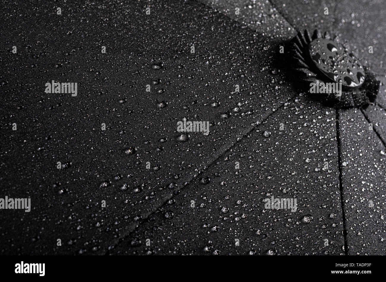 Black waterproof umbrella texture with water droplets Stock Photo - Alamy