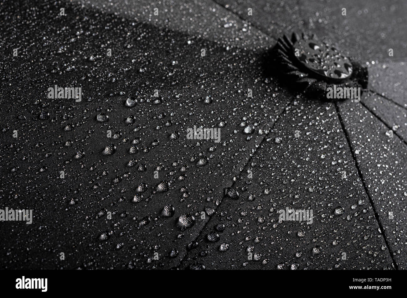 Black waterproof umbrella texture with water droplets Stock Photo - Alamy