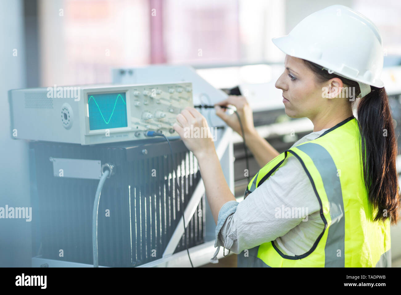Female technician working on oscilloscope Stock Photo - Alamy