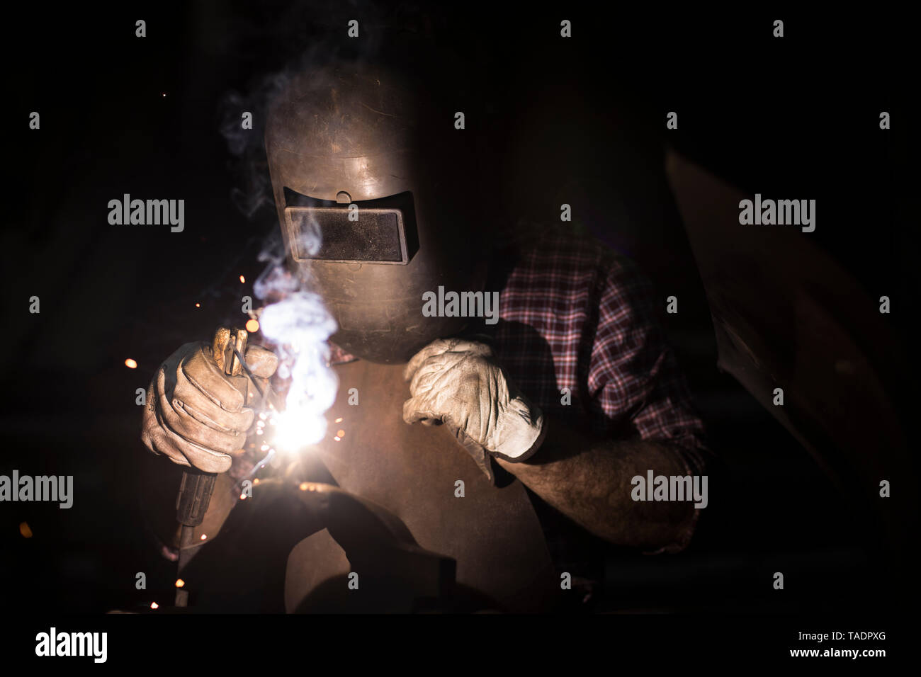 Man welding in his workshop Stock Photo - Alamy