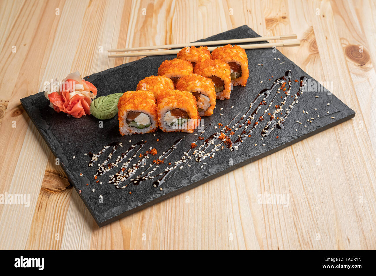 Set of rolls with wasabi and pickled ginger on stone serving board ...