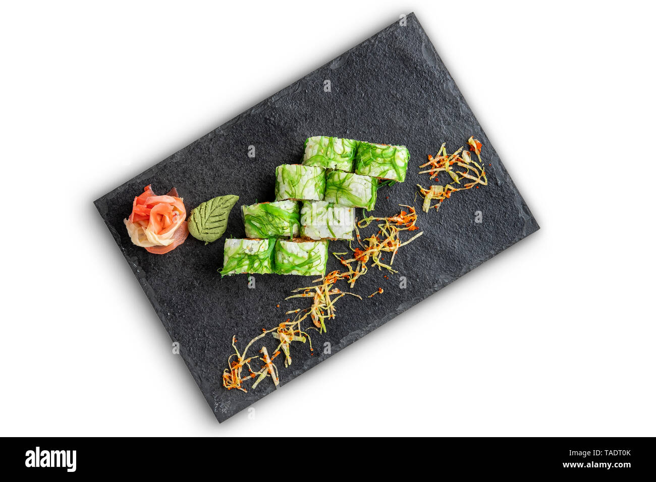 Set of rolls with wasabi and pickled ginger on stone serving board ...
