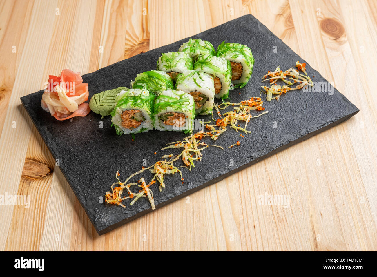 Set of rolls with wasabi and pickled ginger on stone serving board ...