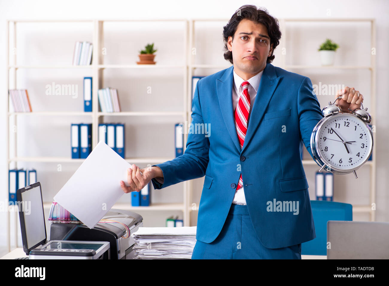Young employee making copies at copying machine Stock Photo - Alamy