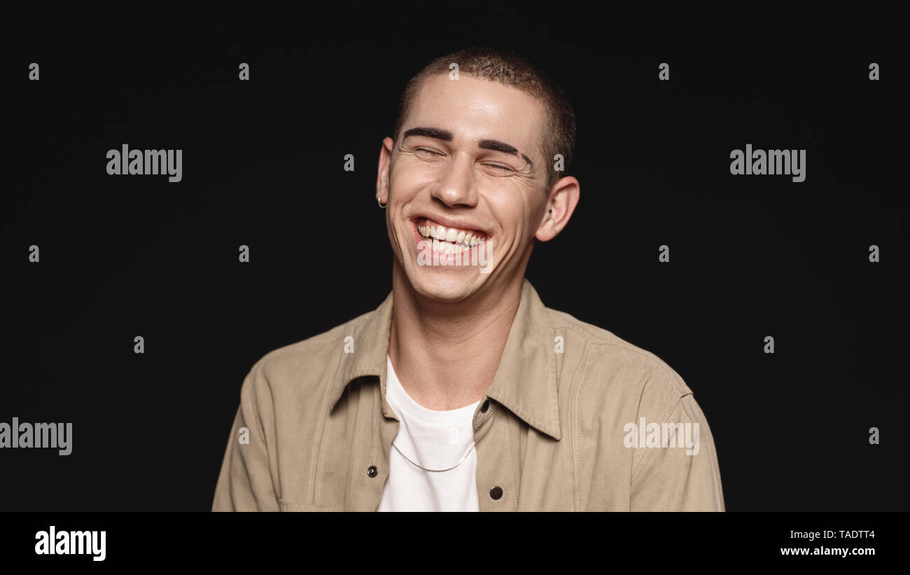 Portrait of a caucasian man laughing with closed eyes. Close up of a ...
