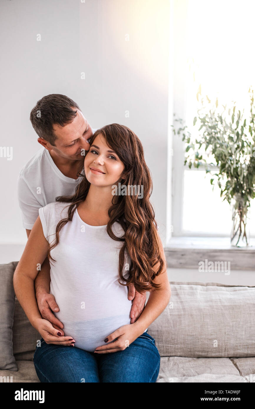 Pregnant couple hug and hold pregnant belly Stock Photo - Alamy
